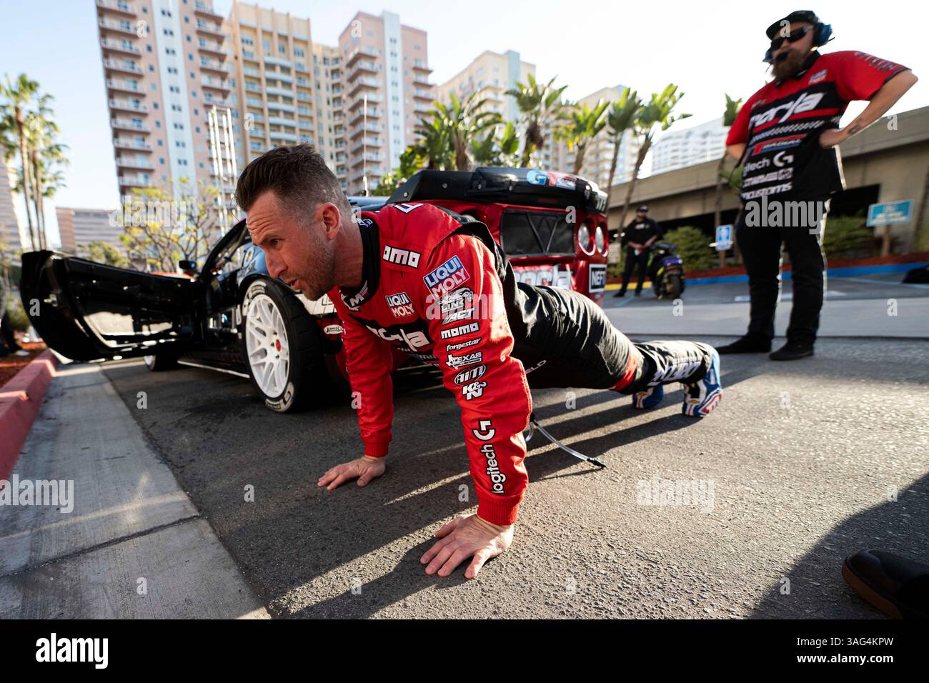 Matt Field driver of the Borla Corvette does push ups to warm up for ...