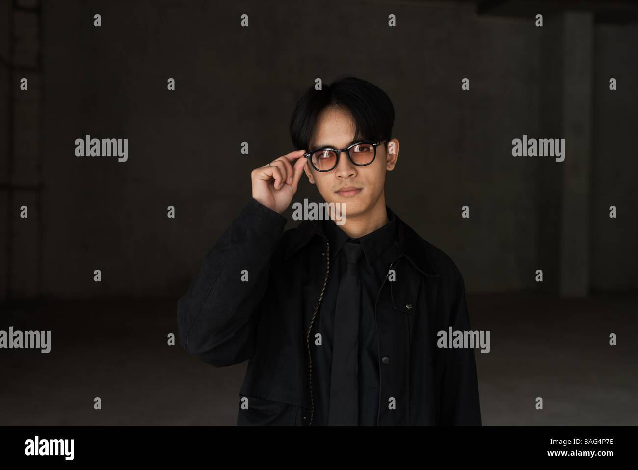 Brutalist style minimalist portrait of young Thai architect in ...