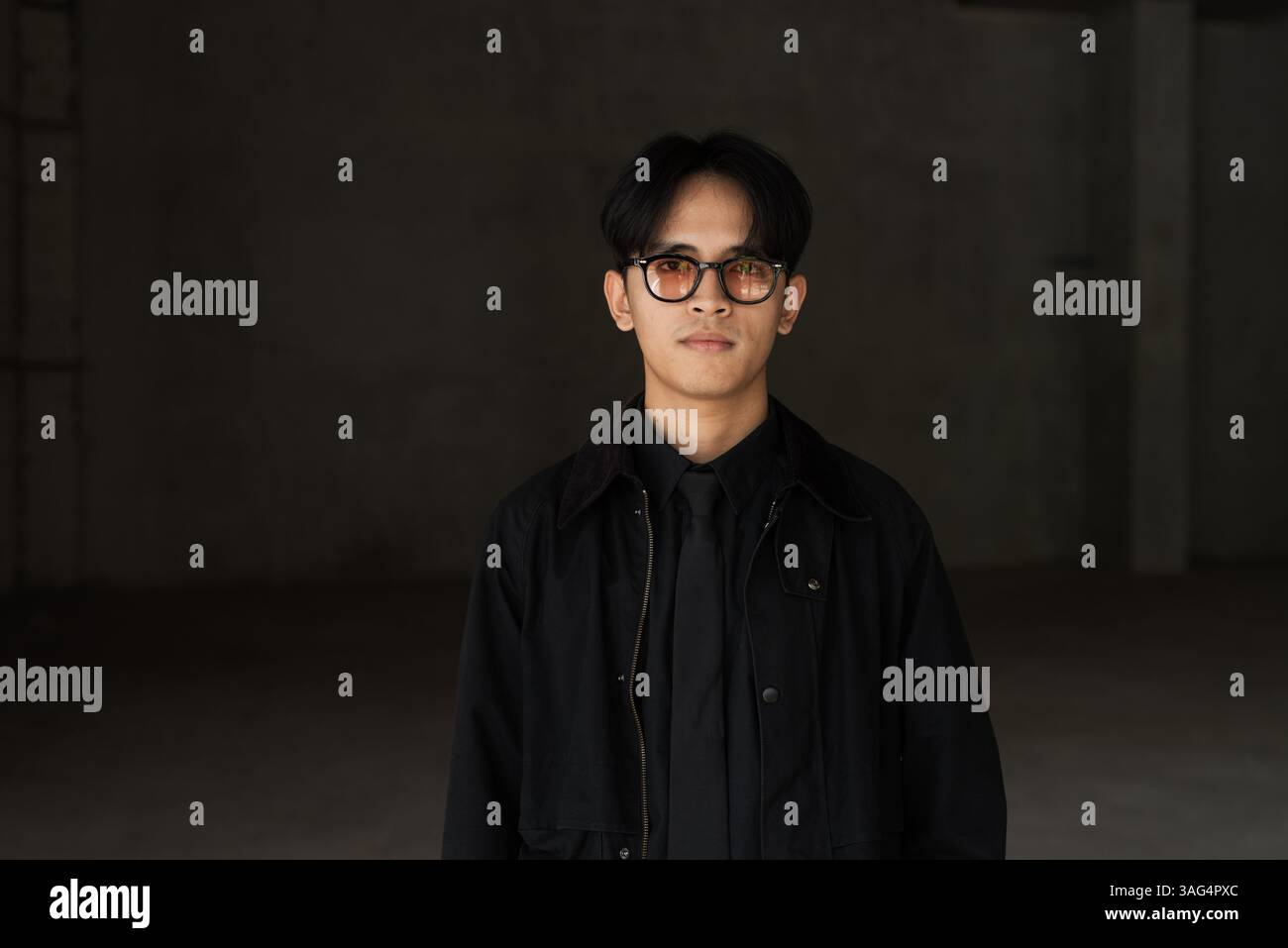 Brutalist style minimalist portrait of young Thai architect in ...