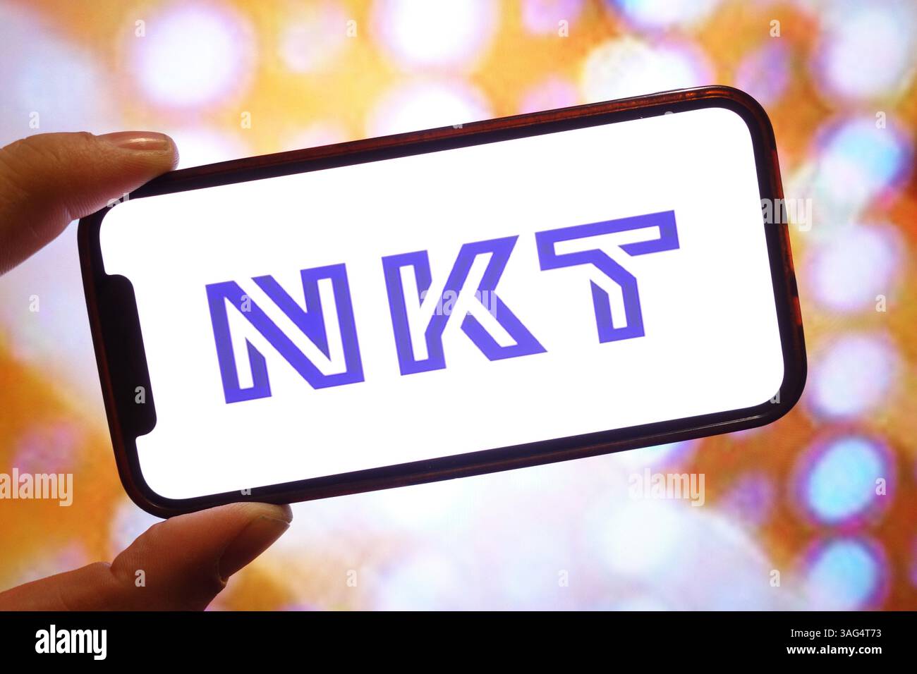 In this photo illustration, the NKT A/S company logo is seen displayed on a smartphone screen ...