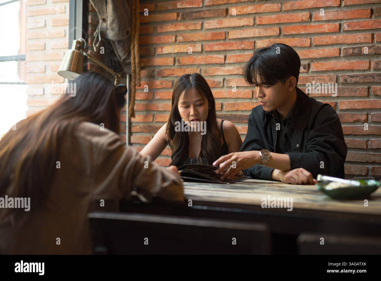 Asian friends eating together in restaurant and ordering food Stock ...