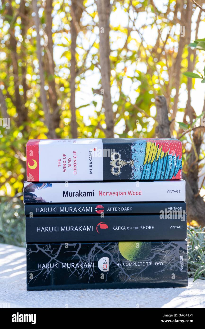 Close-up of Haruki Murakami's novels in the garden. Stack of books ...