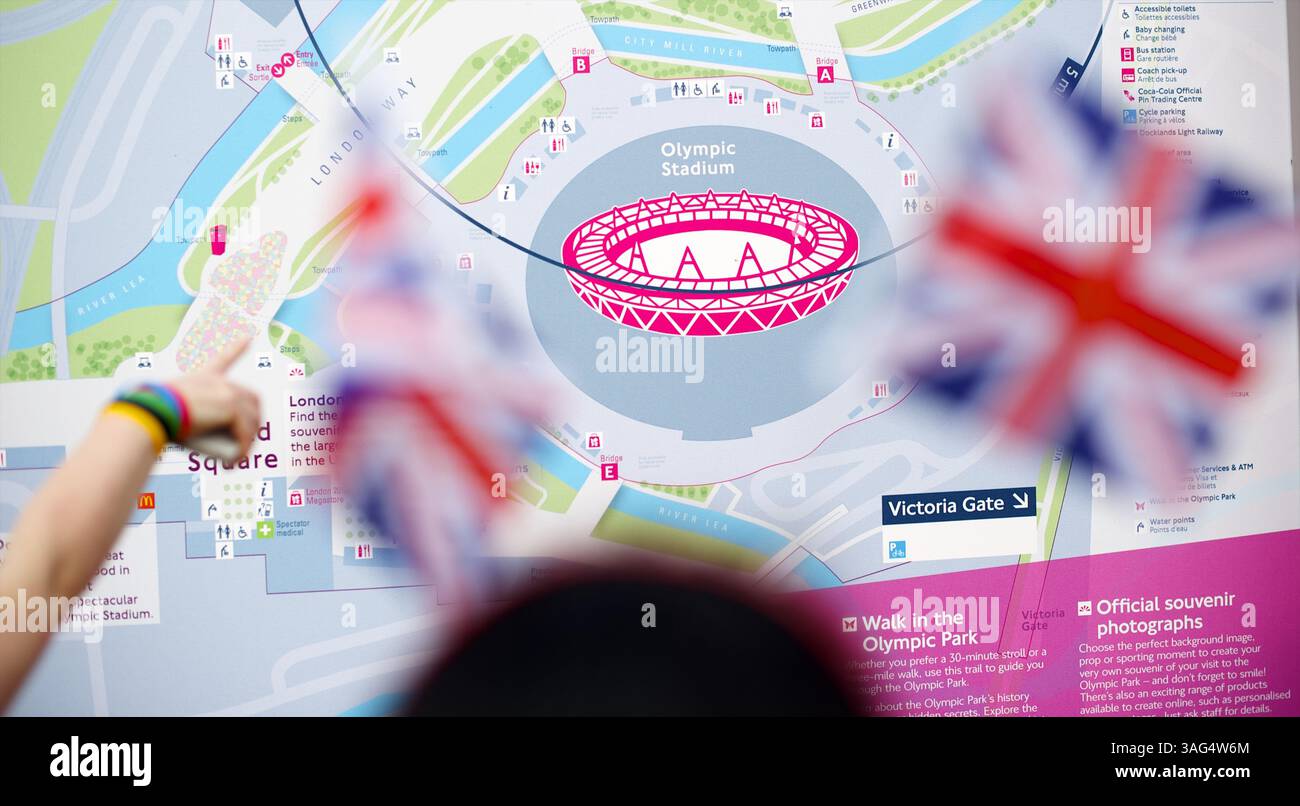 July 27, 2012 - London, England, UK - Attendees consult the Olympic ...