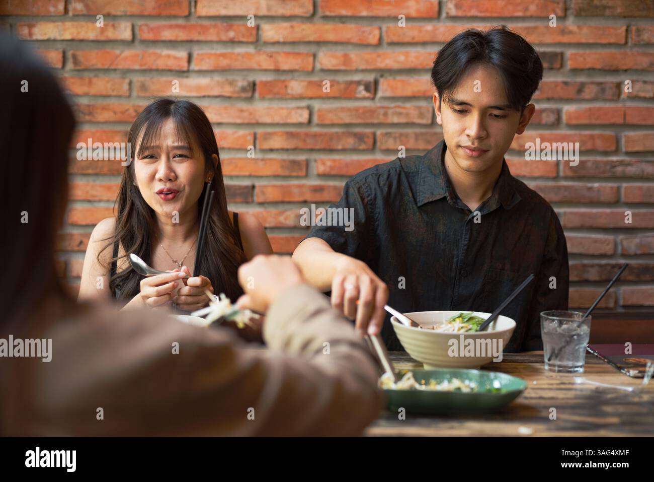 Asian friends eating together in restaurant and having fun Stock Photo ...