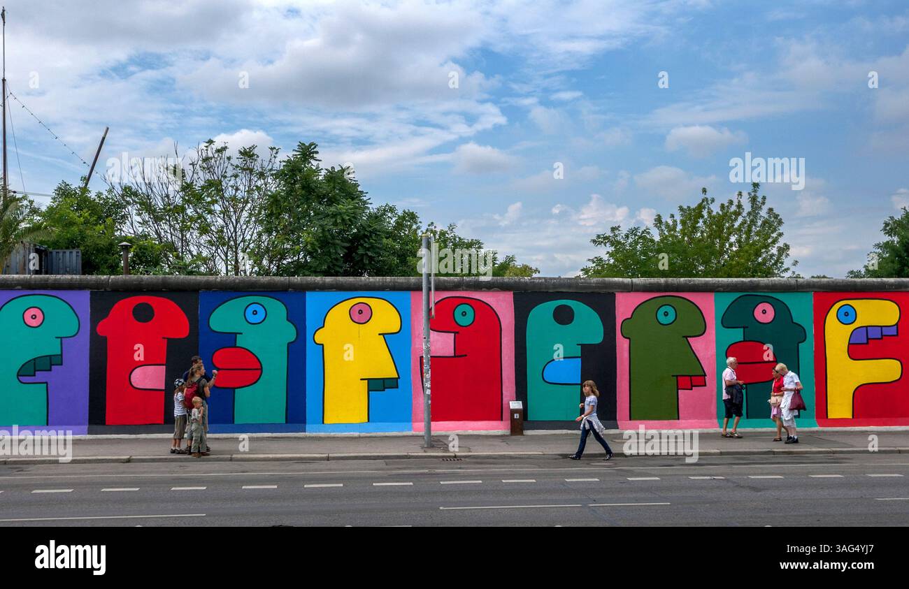 People walk past a section of the former Berlin Wall in Germany now ...