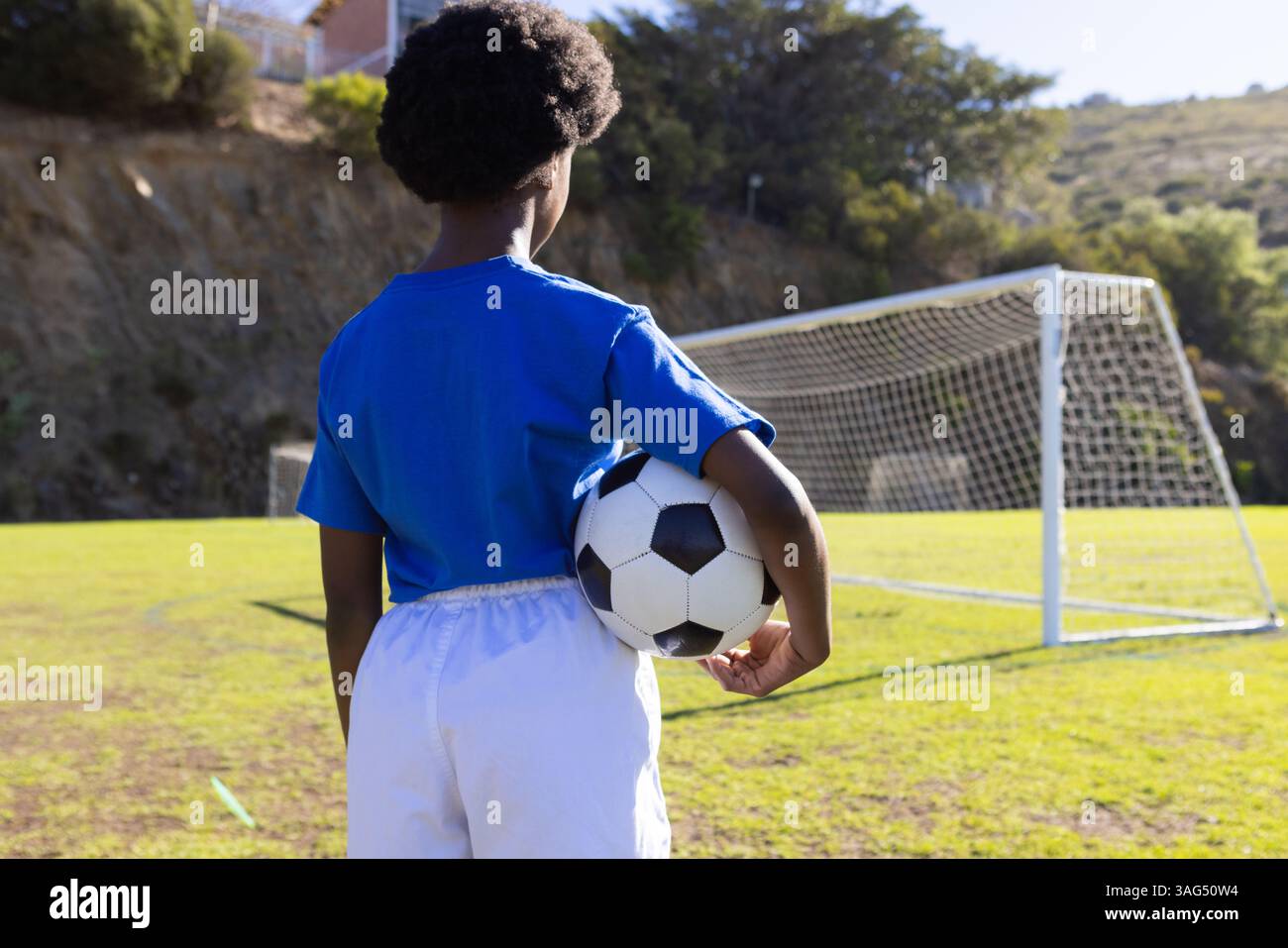 In school, holding soccer ball, african american girl standing on field ...