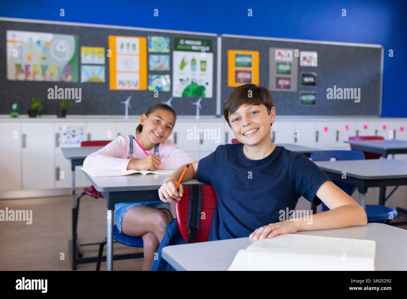 In school, students sitting at desks and smiling in classroom Stock ...