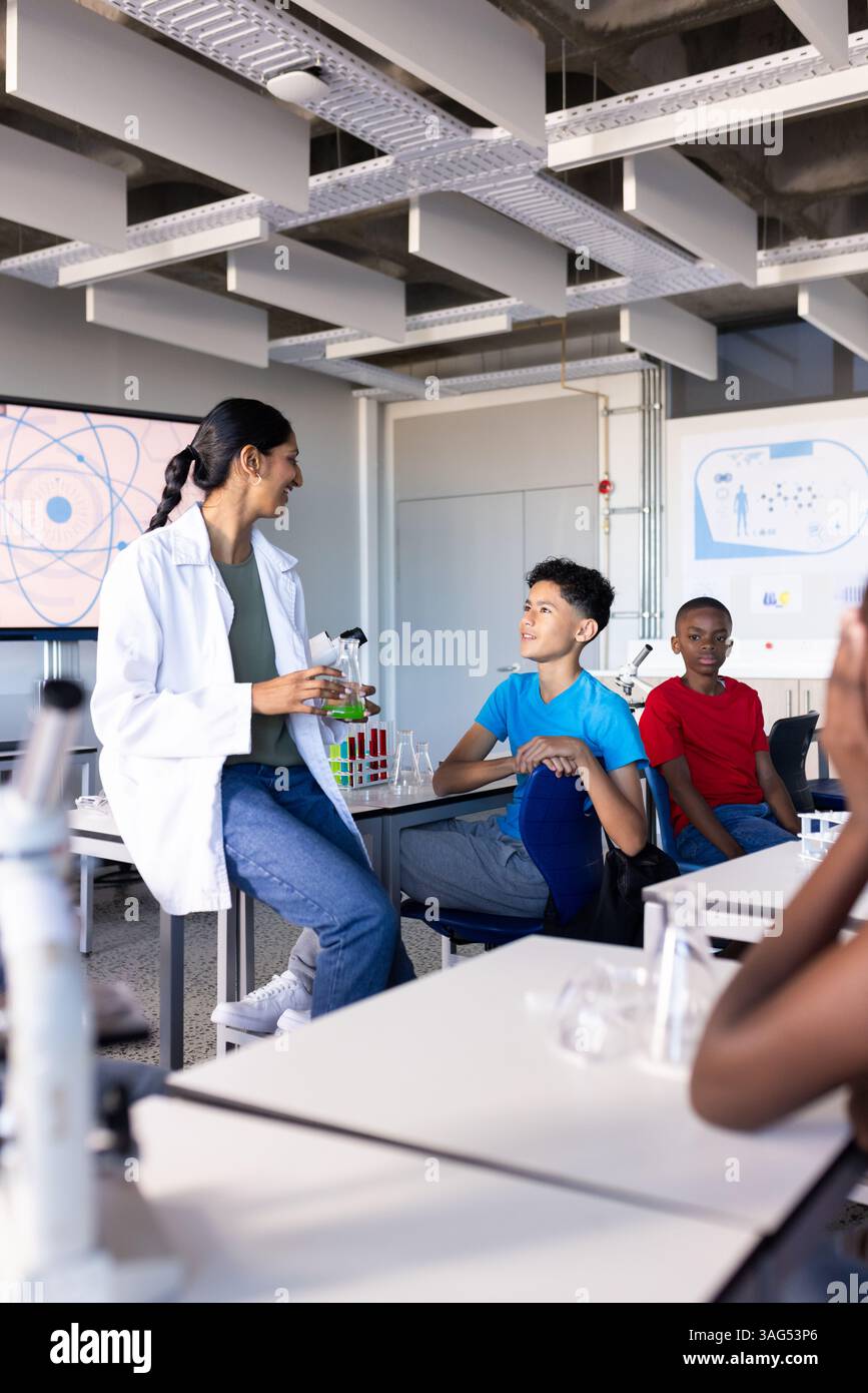 In school, Indian female teacher explaining science experiment to ...