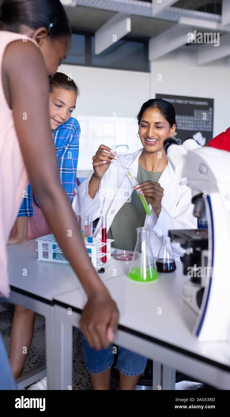 Conducting science experiment with test tubes and beakers, students in ...