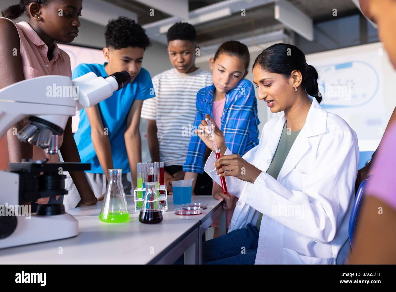 In school teacher using microscope hi-res stock photography and images ...