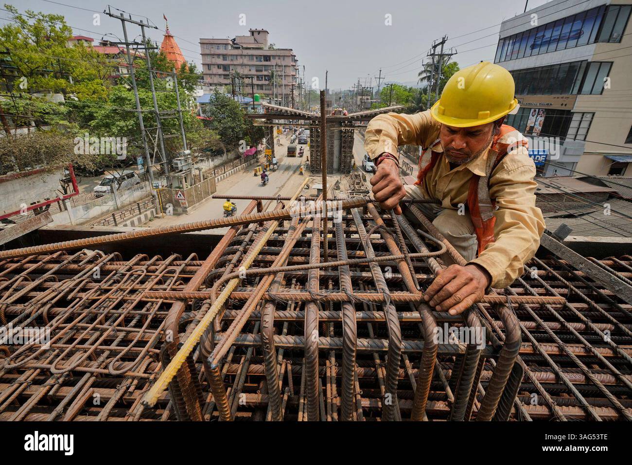A labourer works on the construction of a bridge in Guwahati, India, Tuesday, April 8, 2025. (AP ...