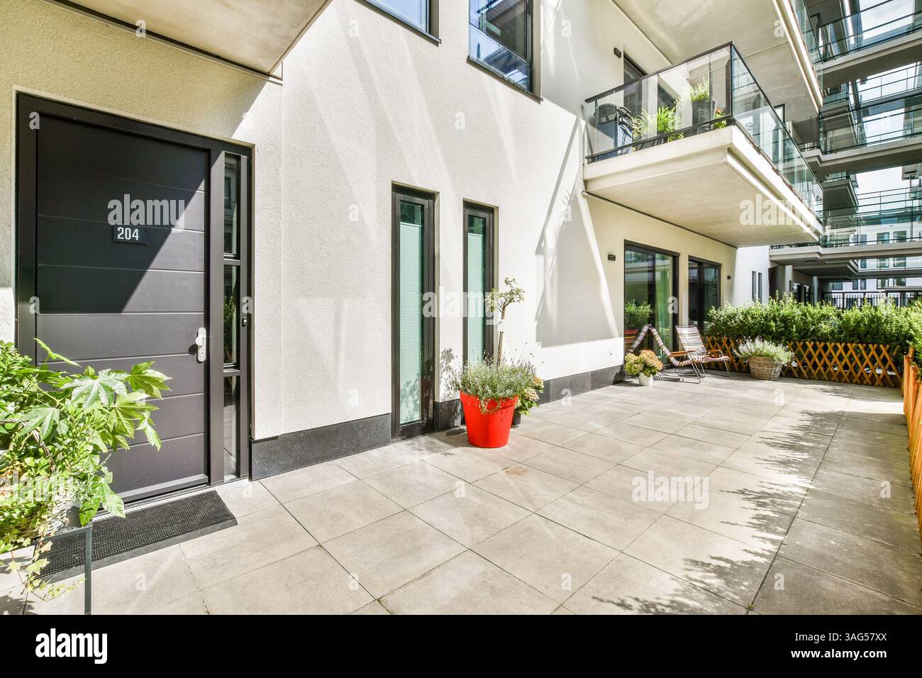 This image showcases a stylish modern apartment entrance surrounded by ...