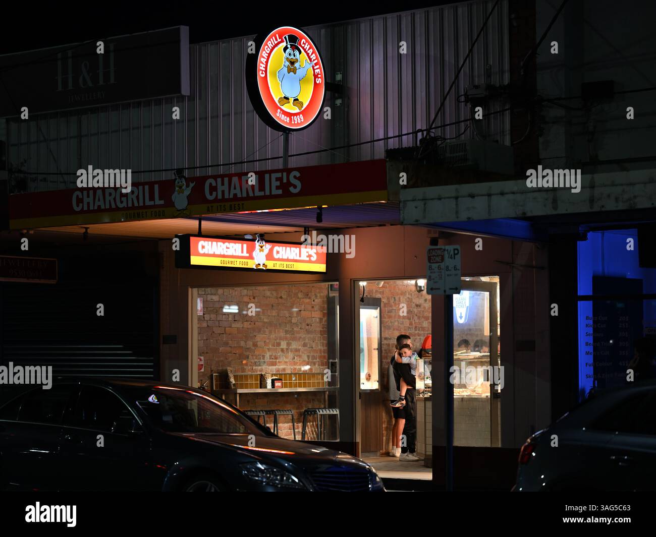 View from outside a Chargrill Charlie's chicken shop at night, with ...