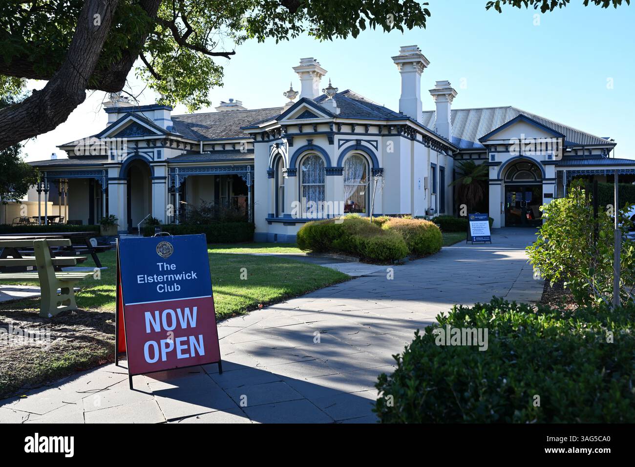 Now open sign at the entrance to The Elsternwick Club, a lawn bowls ...