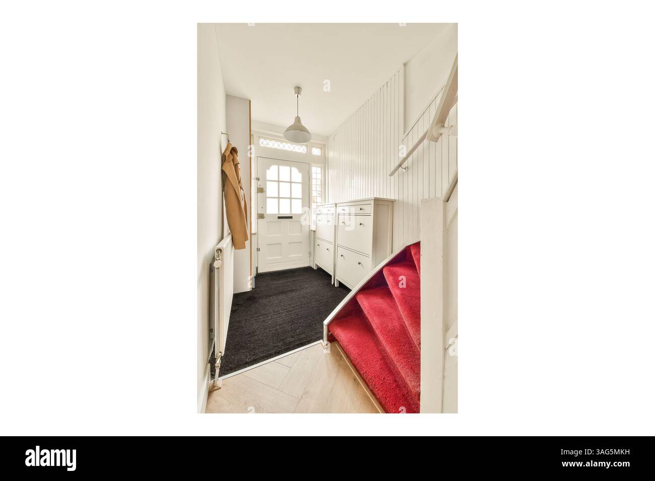 A stylish entryway featuring a vibrant red carpet contrasting against ...