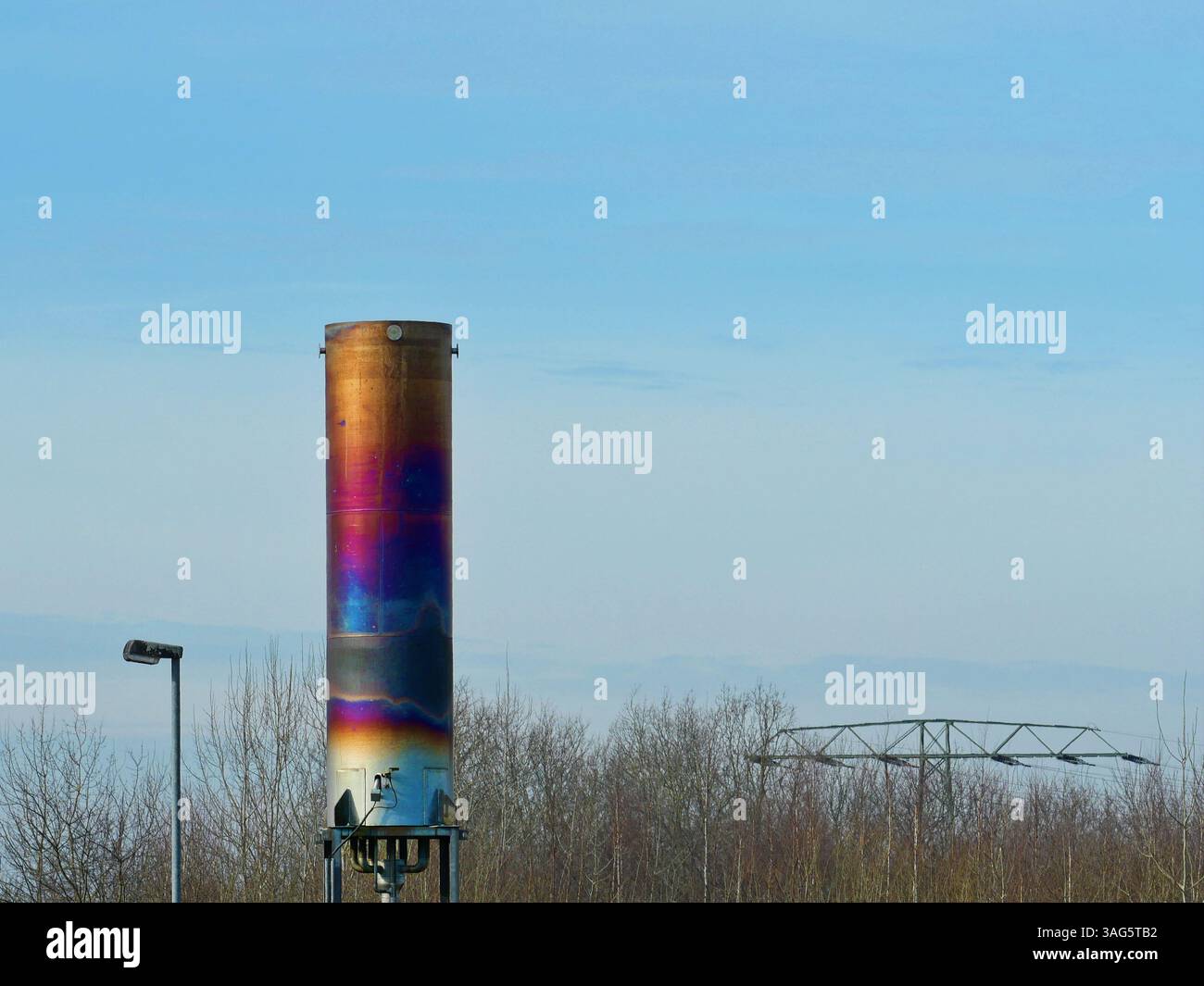 The gas flare of a biogas plant glows intensely from combustion heat ...