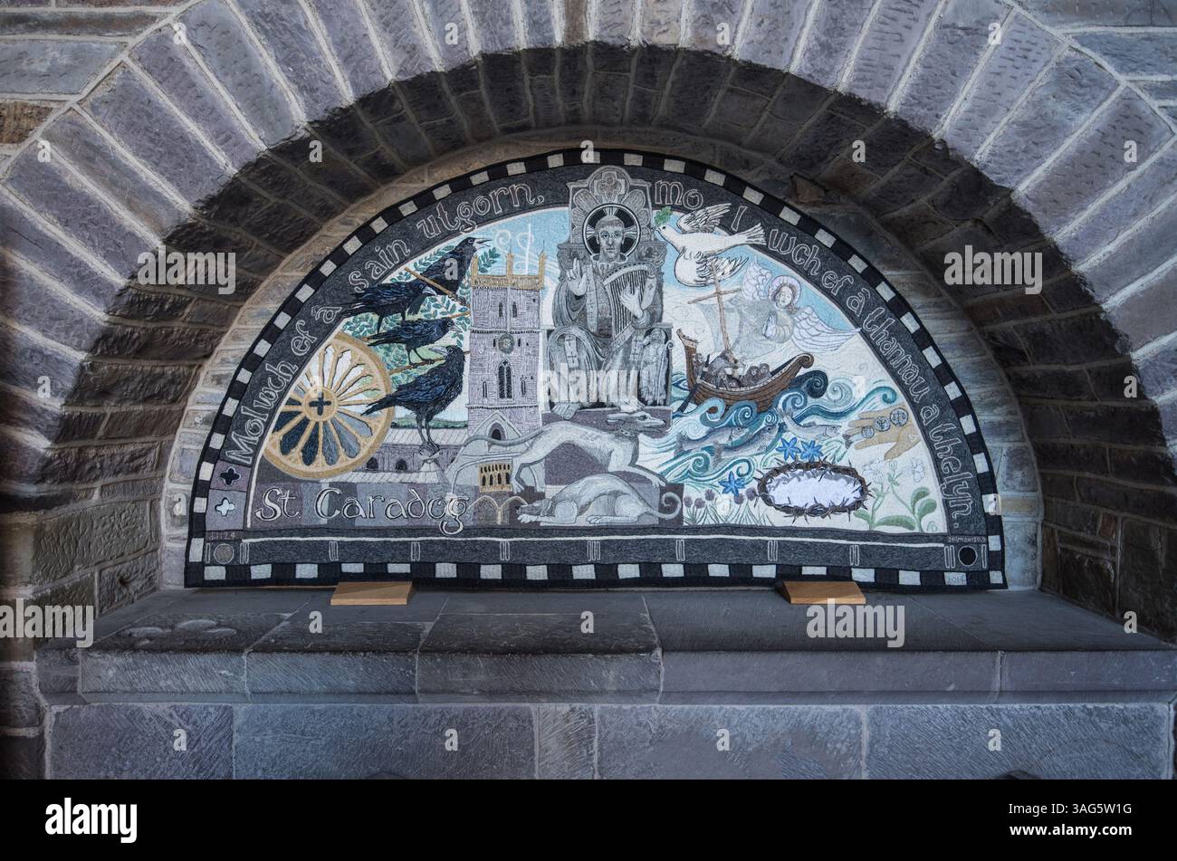 Between the shelf & the arch of the tomb is a tapestry embroidered with ...