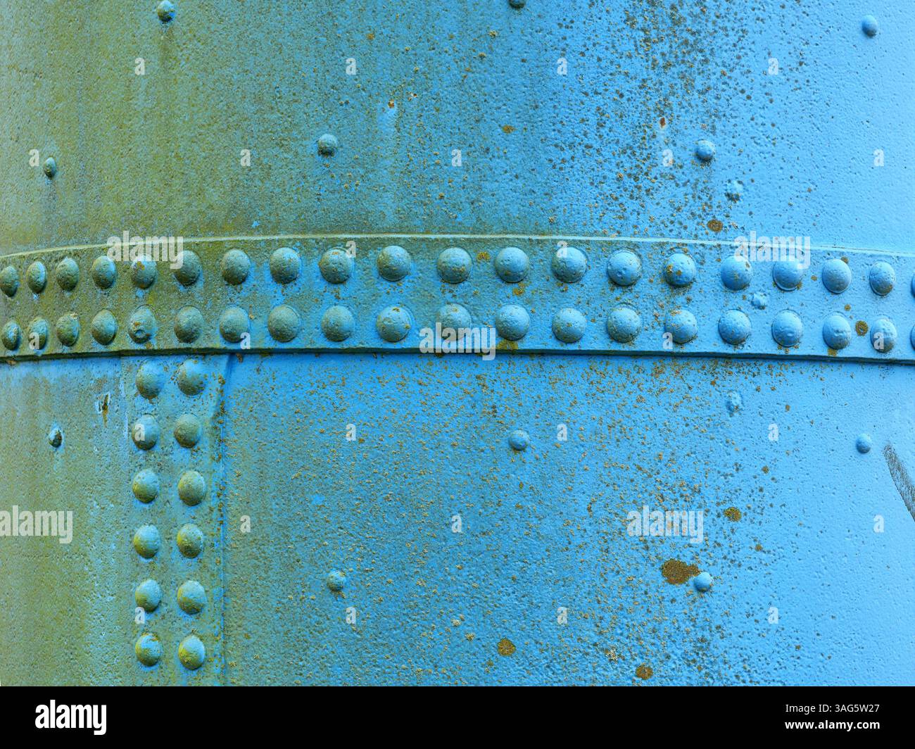 Light blue riveted metal wall of a tank with a striking retro look ...
