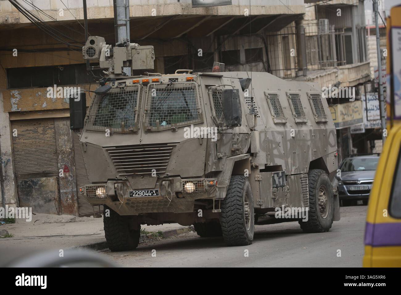 Israeli army armoured vehicles moves along a road during a military ...