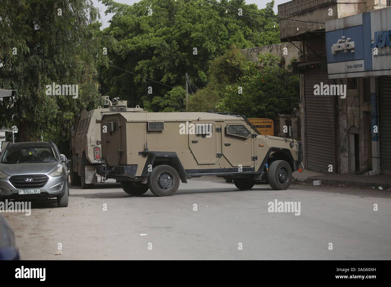 Israeli army armoured vehicles moves along a road during a military ...