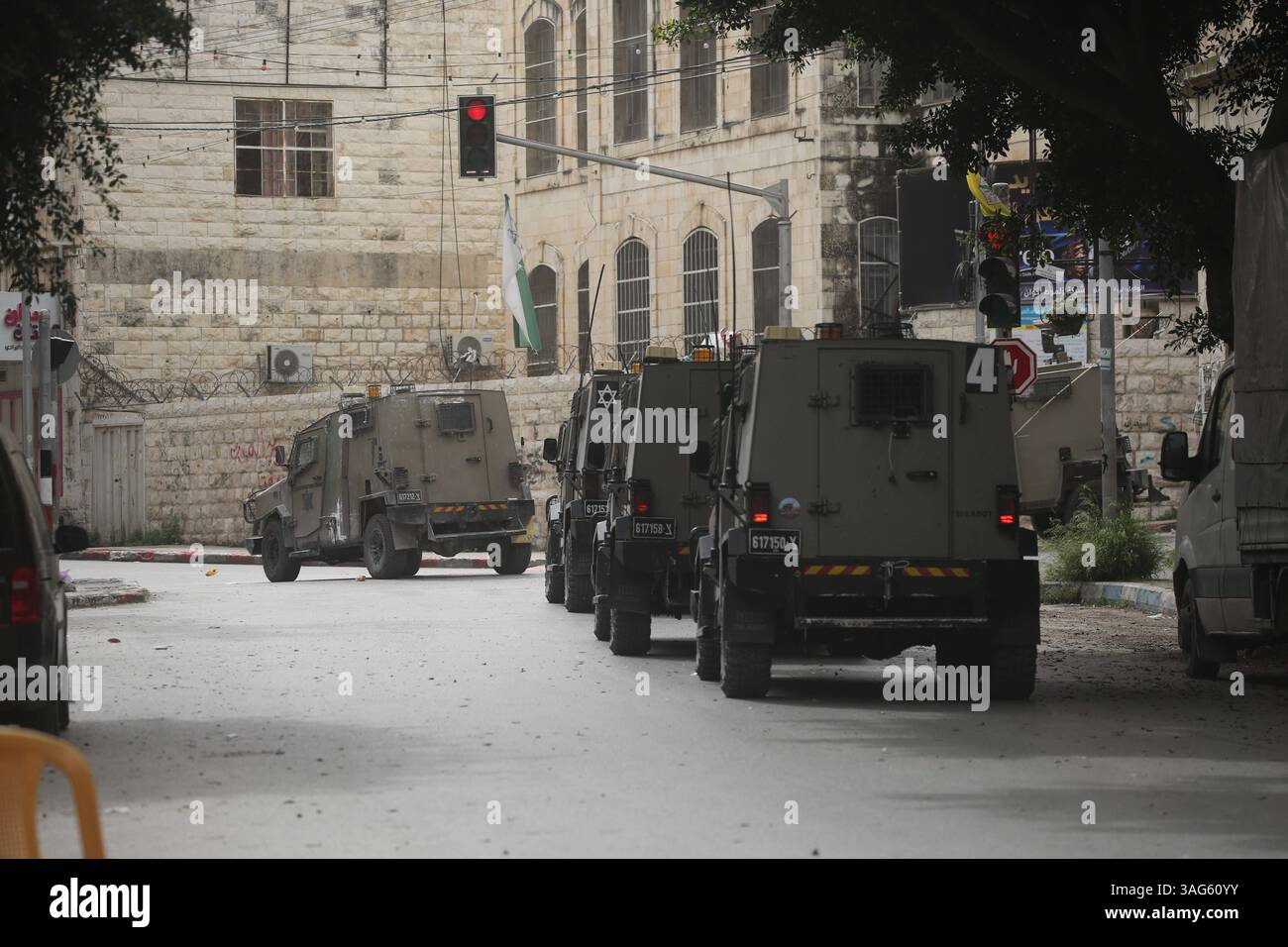 Israeli army armoured vehicles moves along a road during a military ...