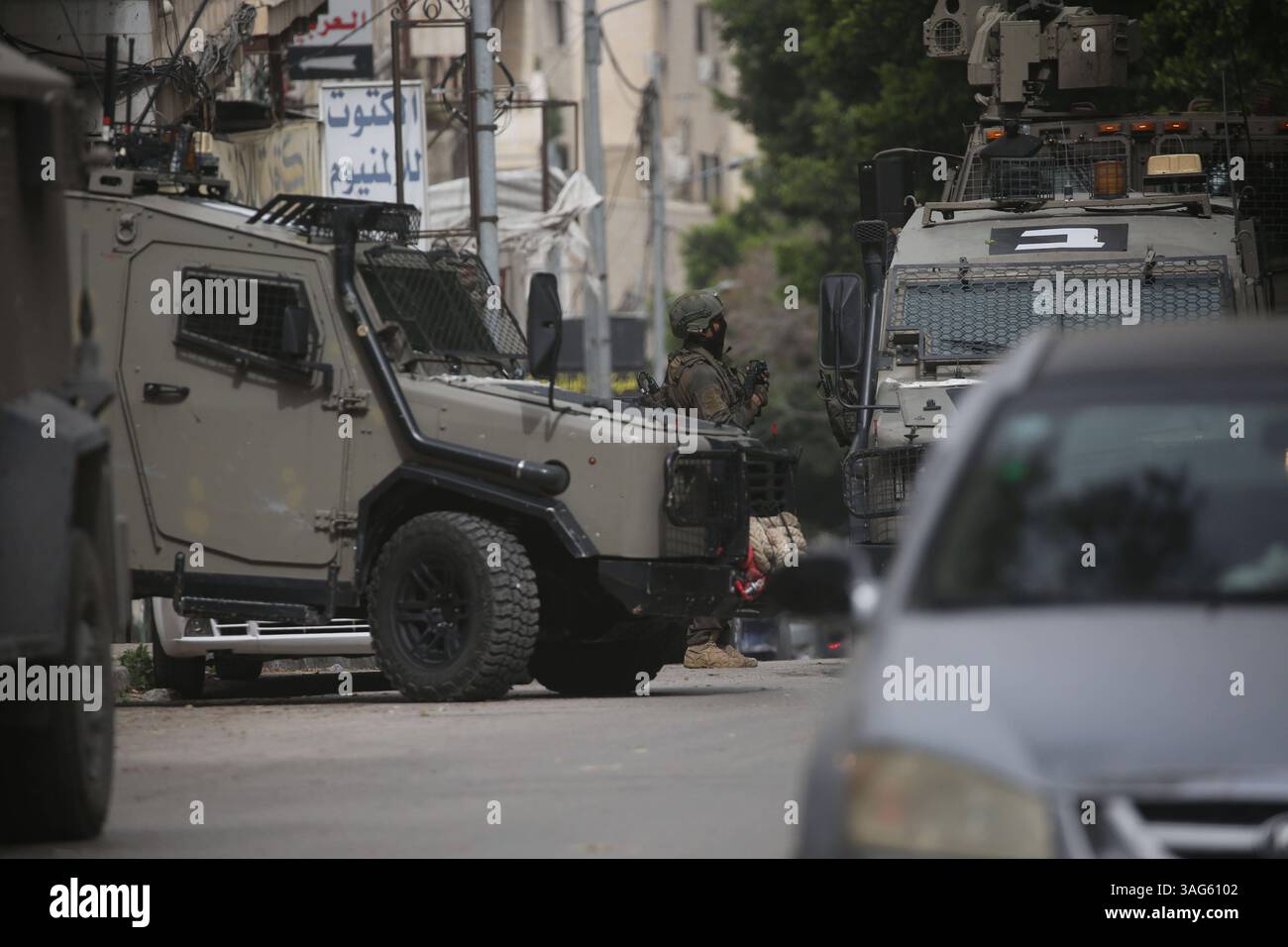 Israeli army armoured vehicles moves along a road during a military ...