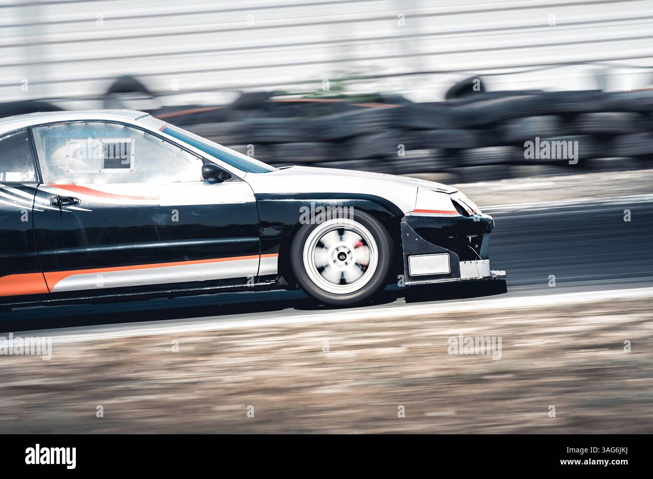 Racing Sports Car Speeding Across Circuit Track Demonstrating High