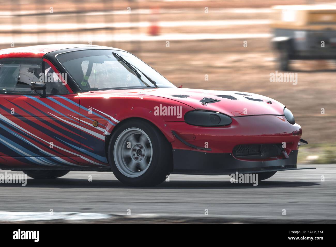 Professional racing vehicle accelerating around circuit during high ...