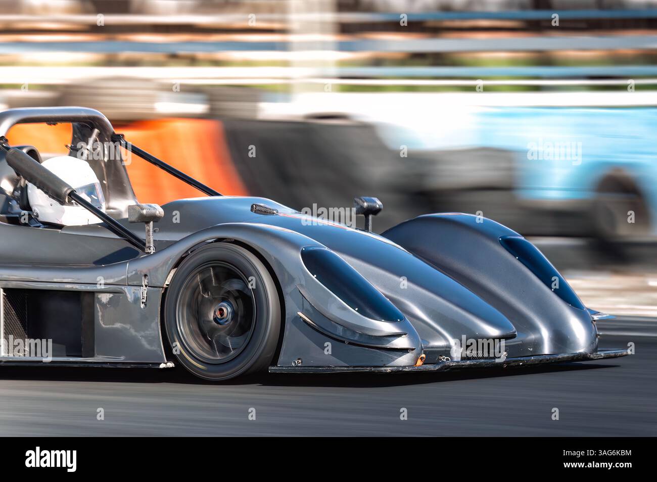 Professional racing car accelerating on track with blurred background ...