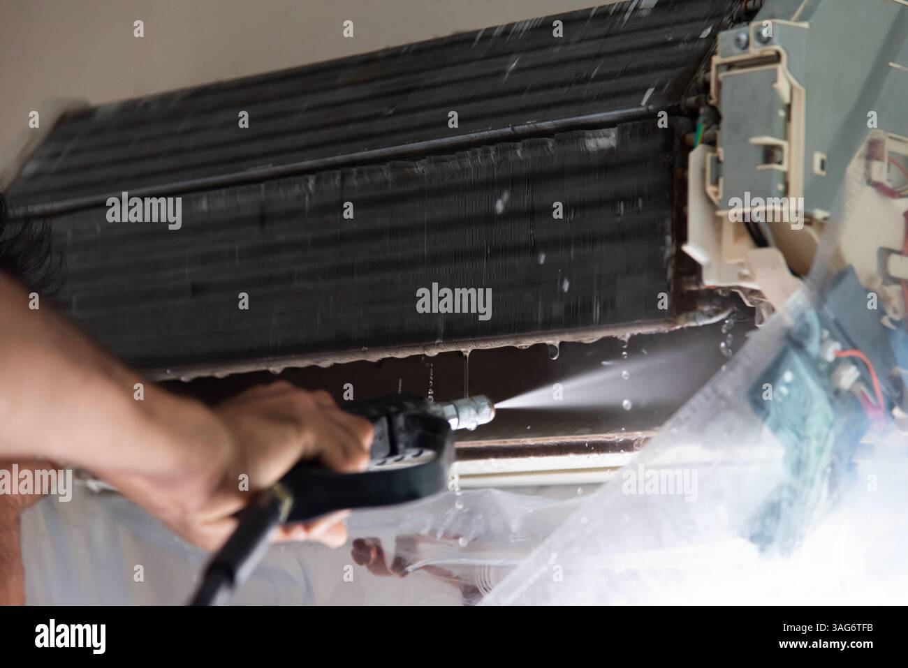 Worker to cleaning coil cooler of air conditioner by water for clean a ...