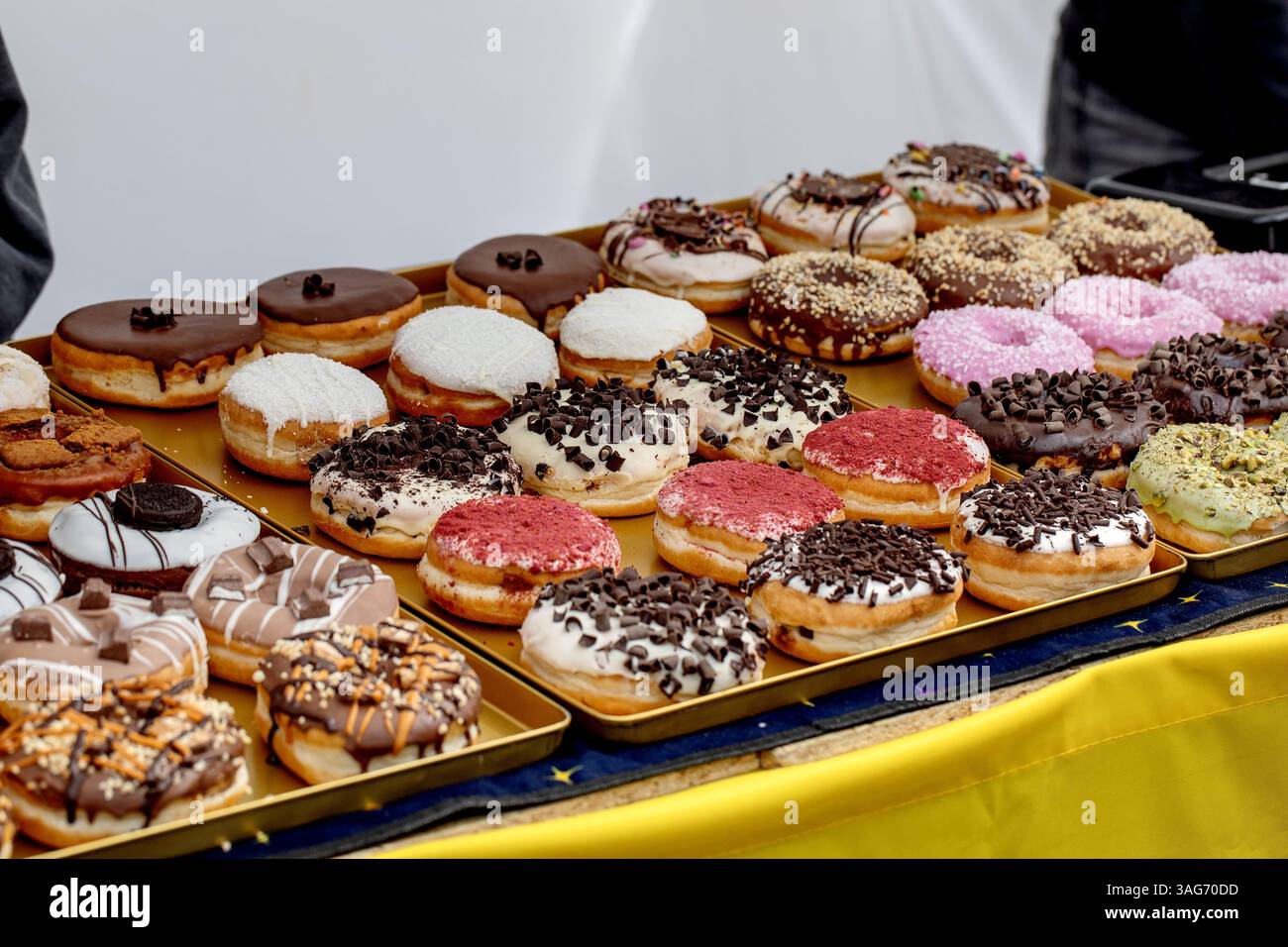 Variety of fresh donuts with different toppings including chocolate ...