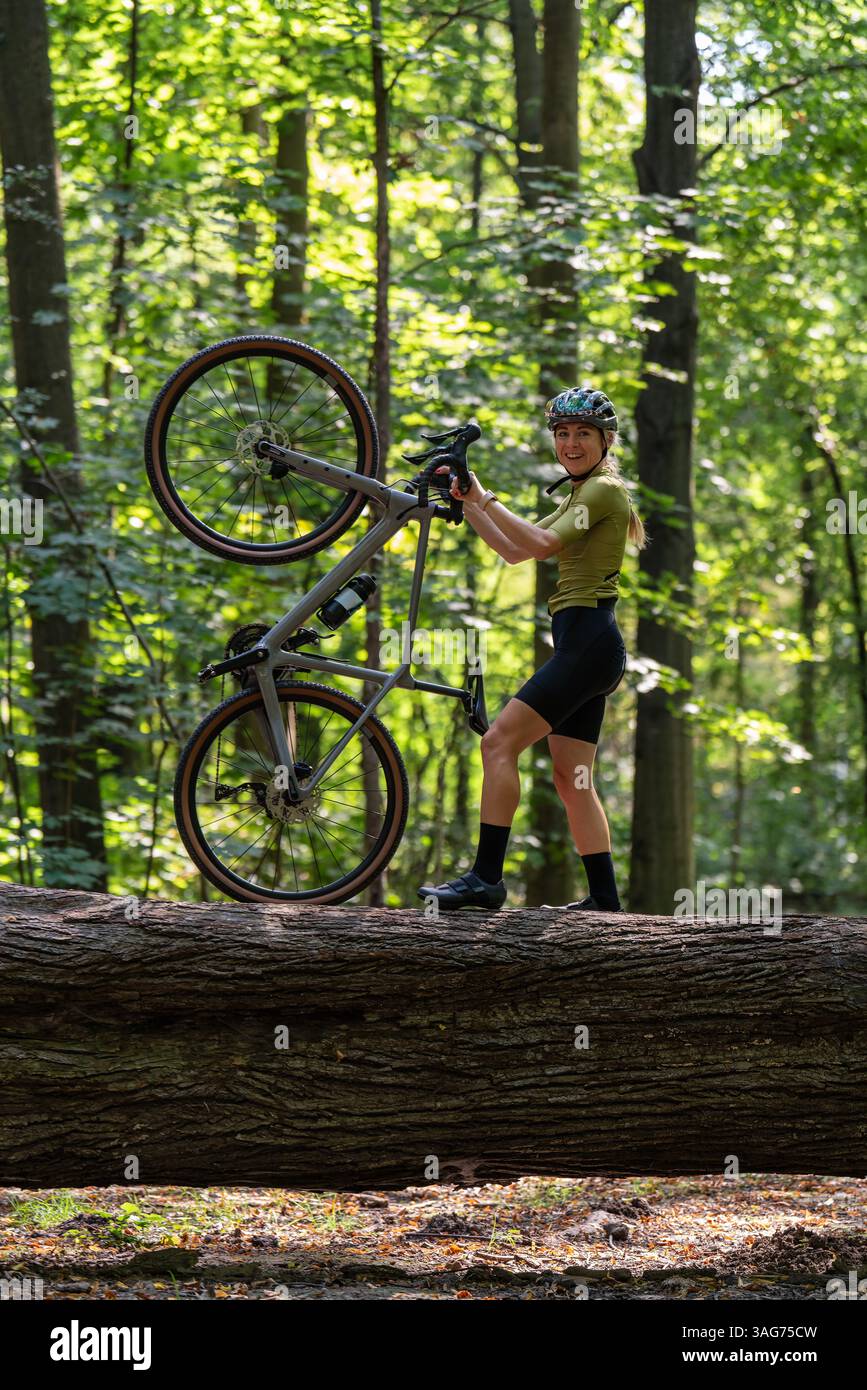 Stunning female cyclist, wearing helmet and green athletic outfit ...