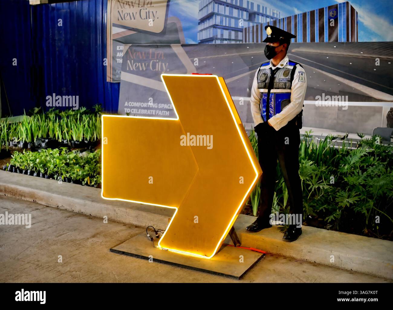 Security guard oversees the flow of vehicles using a new route into the ...