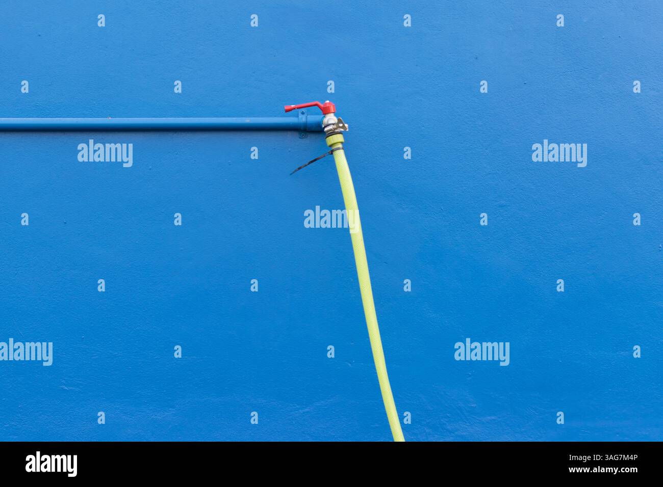 Minimalism style, Faucet metal with green water rubber tube and blue ...