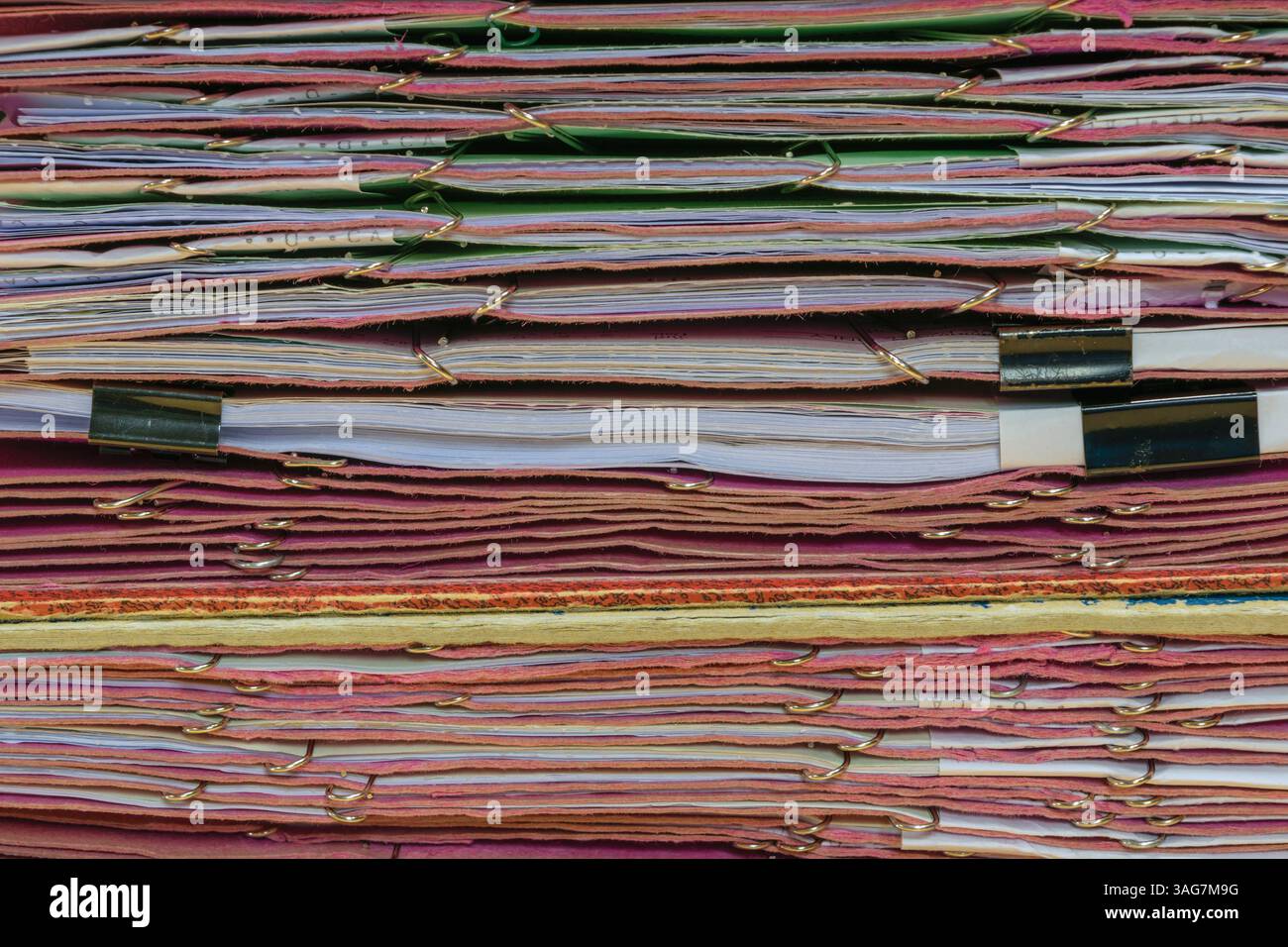 Files in old folder stacking up in a messy order Stock Photo - Alamy