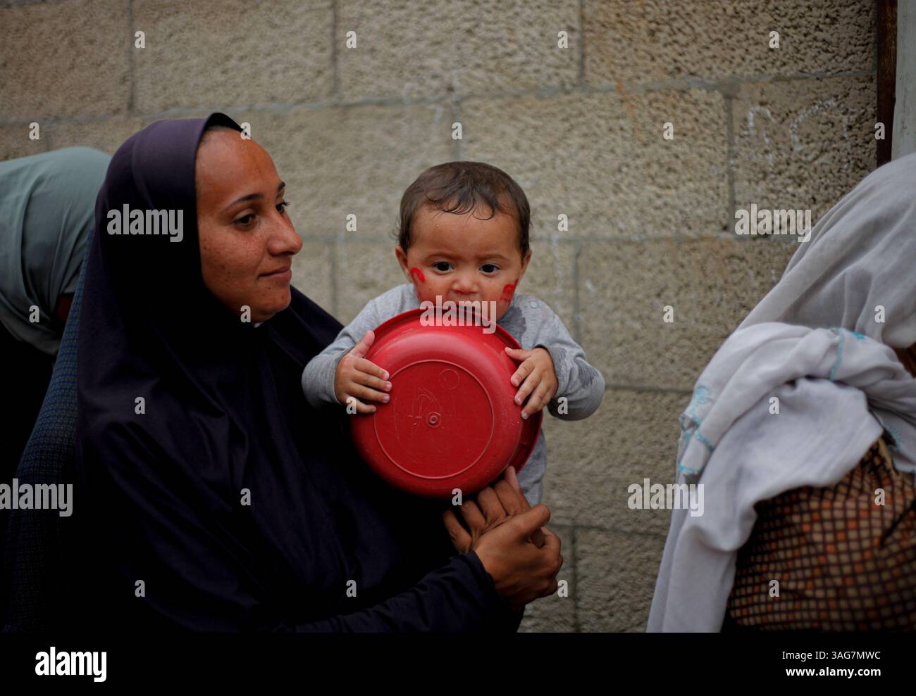 Palestinians gather in large numbers to receive the meals distributed ...