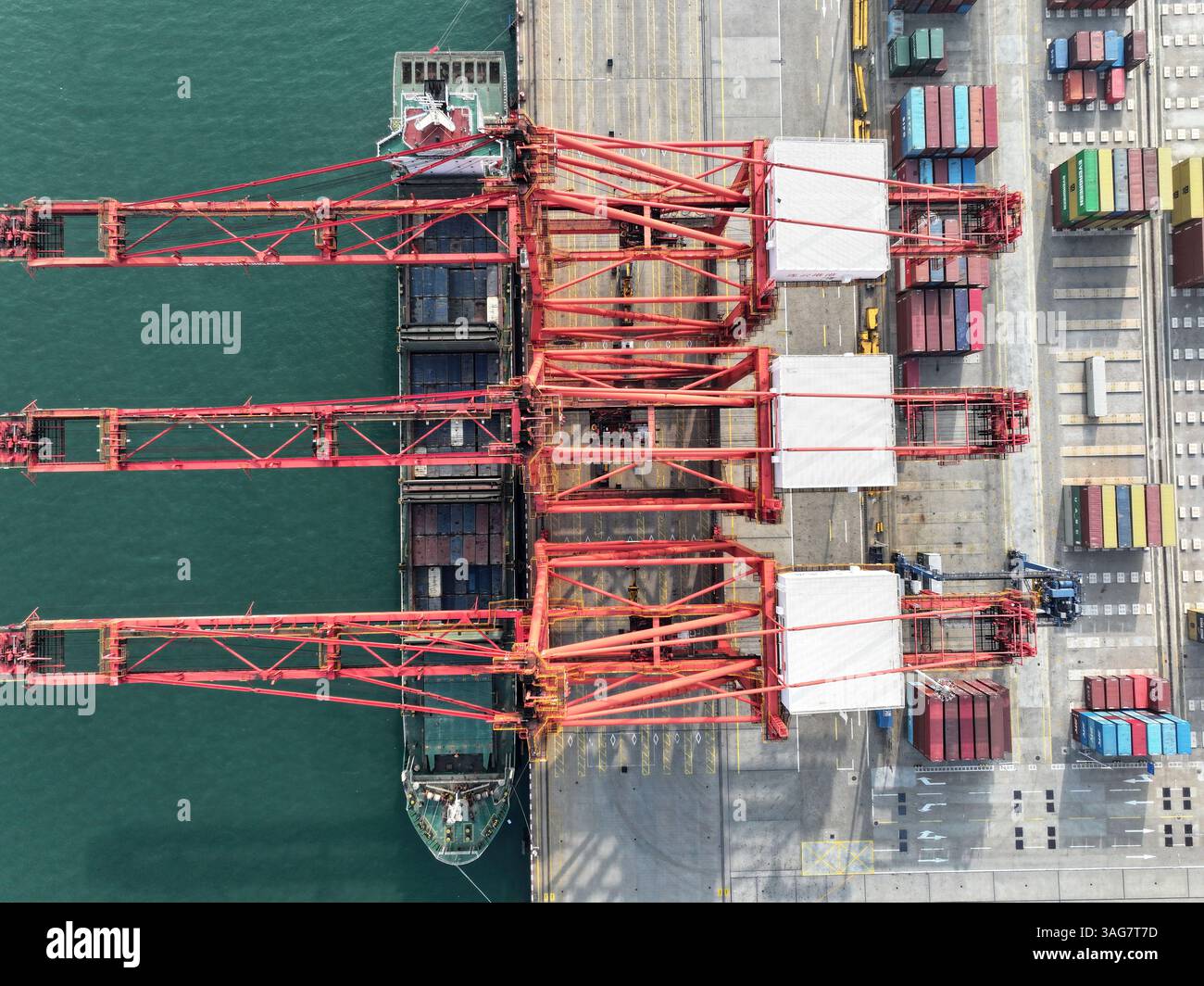 Cargo ships stop at their berths to load and unload containers at the ...