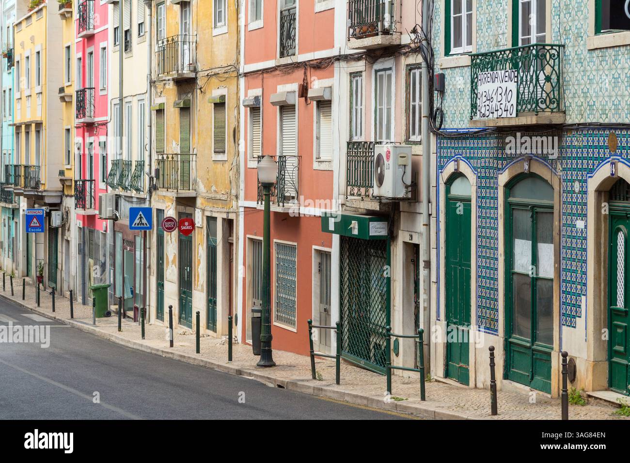 Colorful traditional facades line a quiet street in Lisbon, Portugal ...