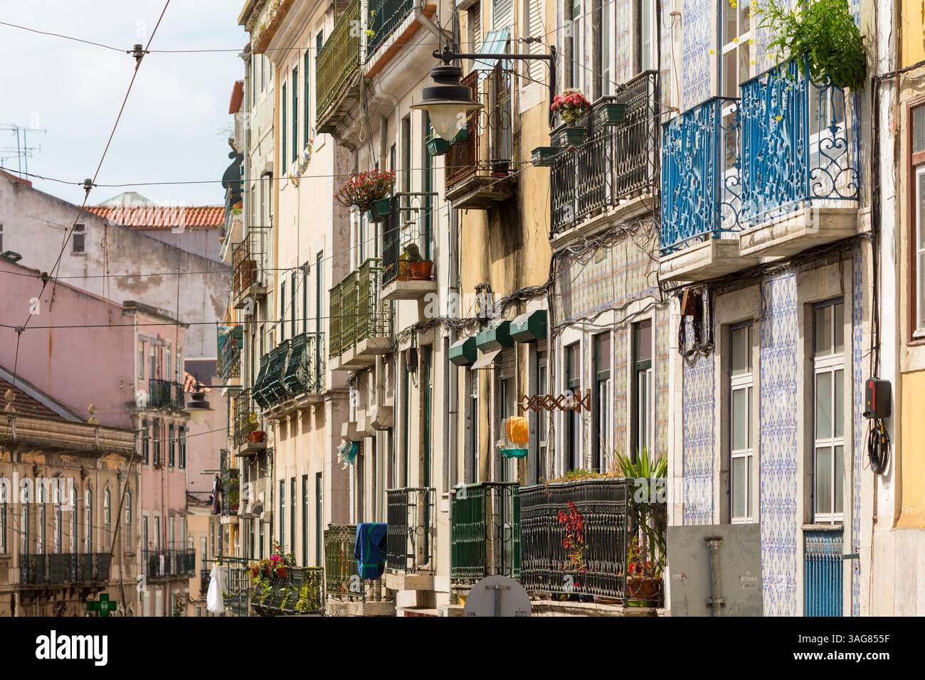Colorful traditional facades line a quiet street in Lisbon, Portugal ...