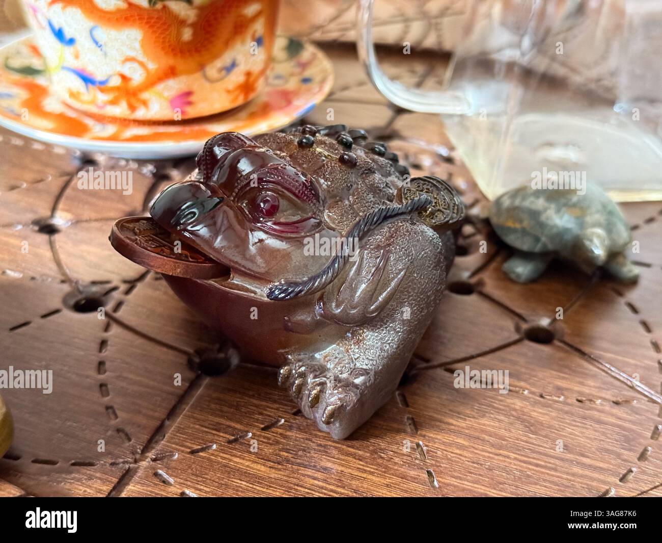Fortune frog with coin on tea table during traditional tea ritual ...