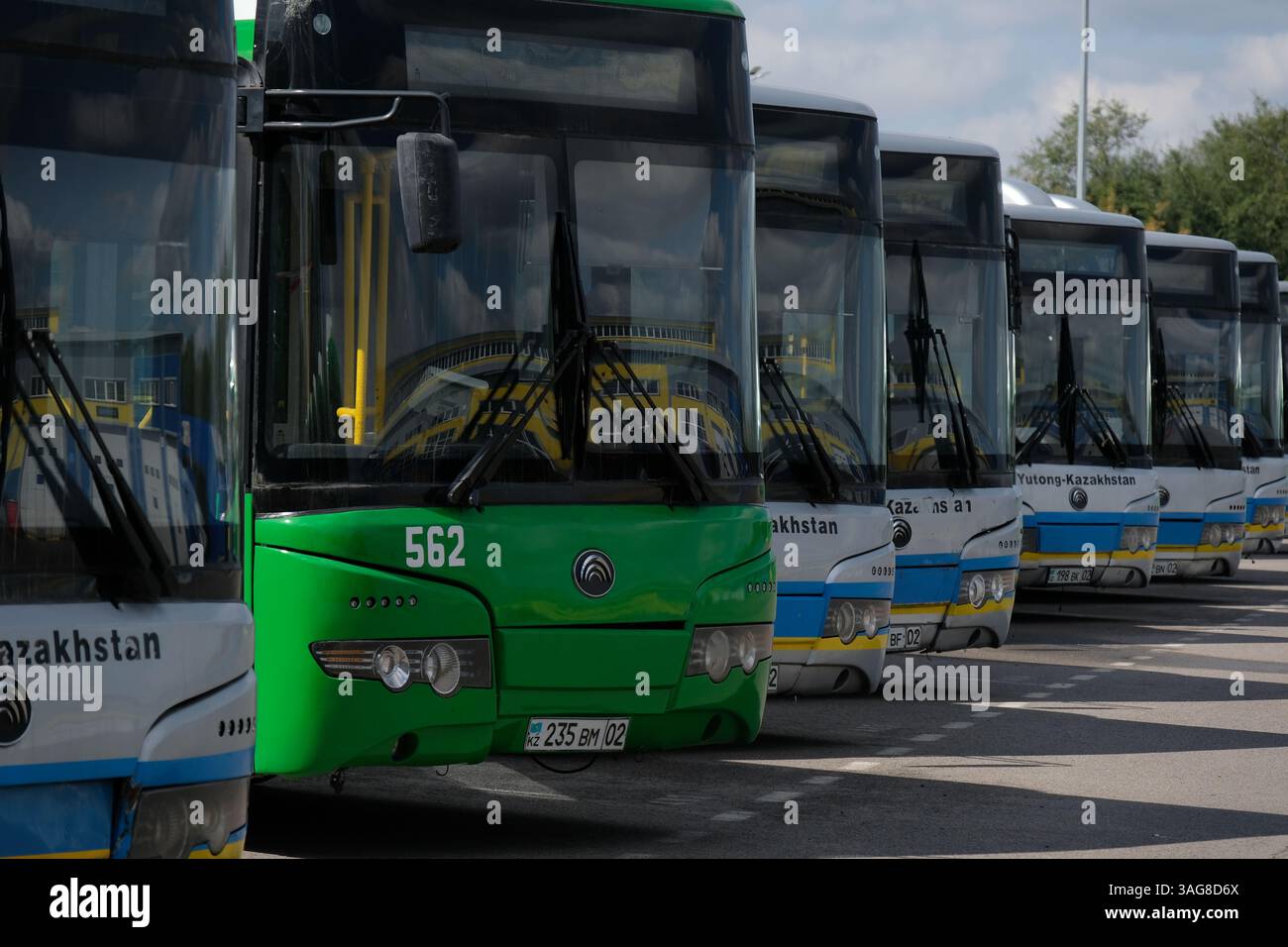 City buses stand behind each other in a large Parking lot of the fleet ...