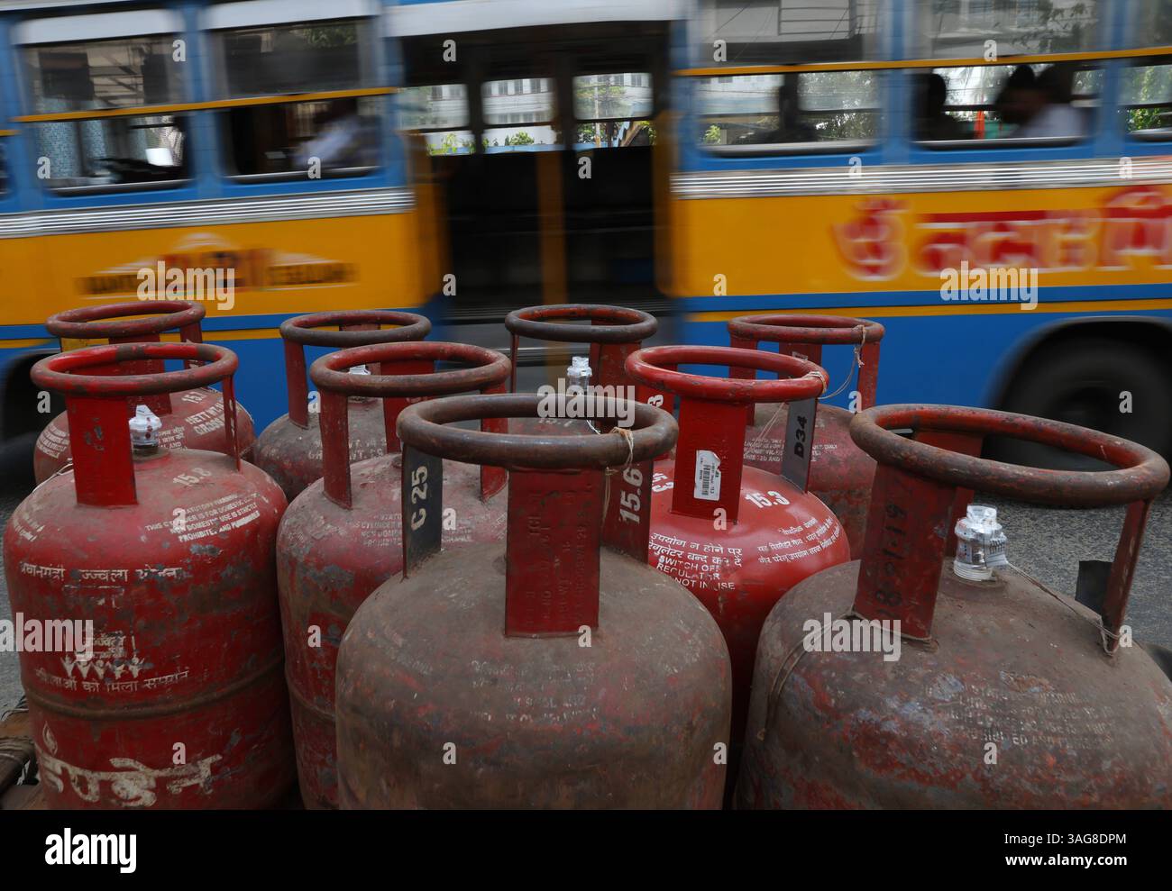 LPG gas price hike in India A bus passes Liquefied Petroleum Gas LPG cylinders in Kolkata, India ...