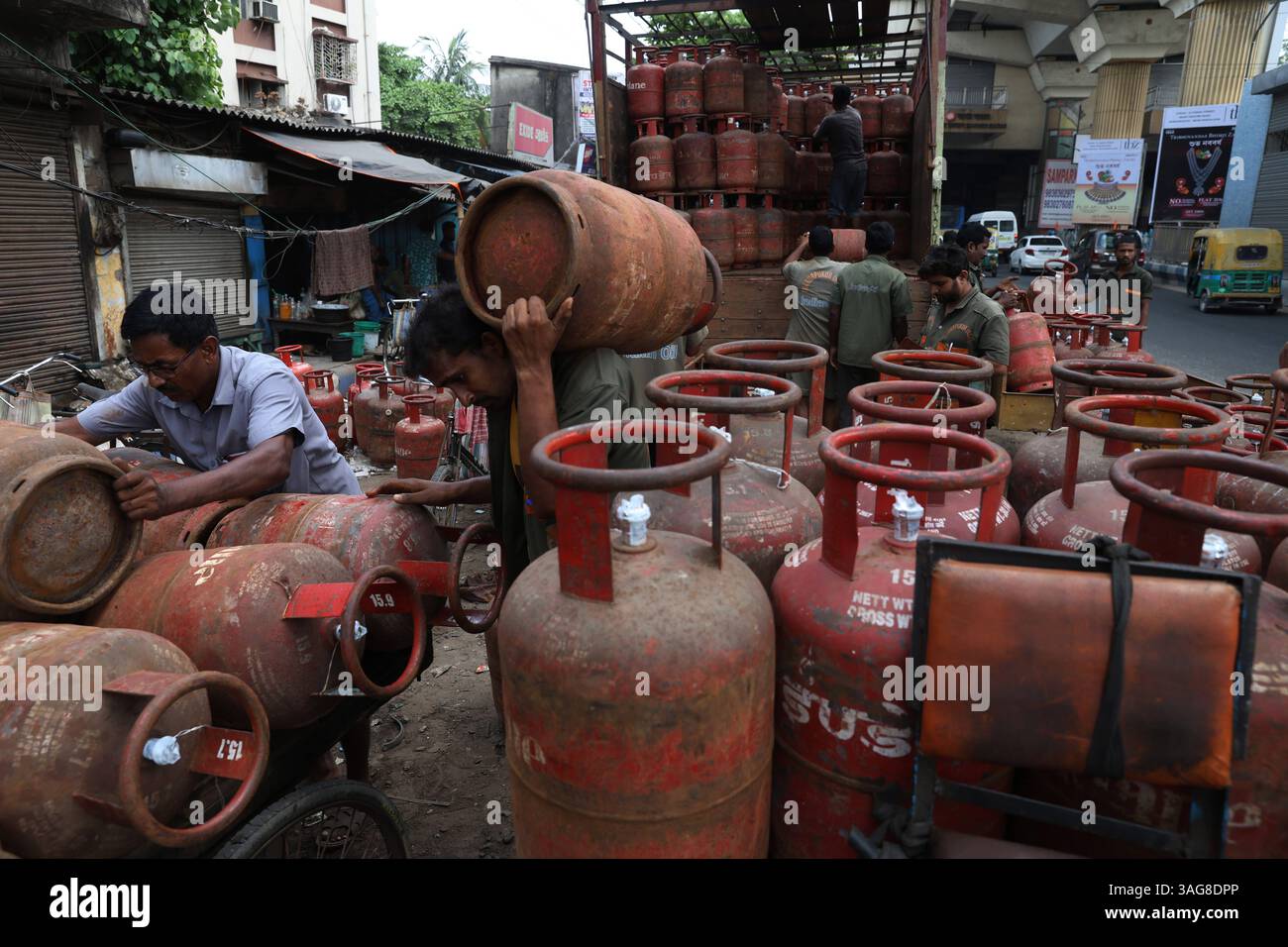 LPG gas price hike in India A worker offloads Liquefied Petroleum Gas ...