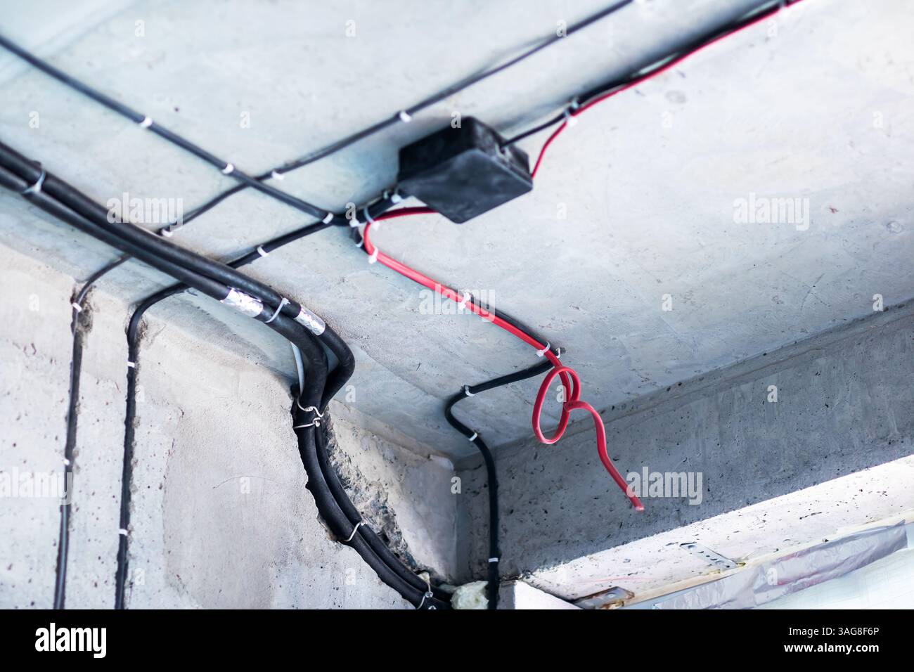 A bunch of wires are currently hanging down from the ceiling, creating ...