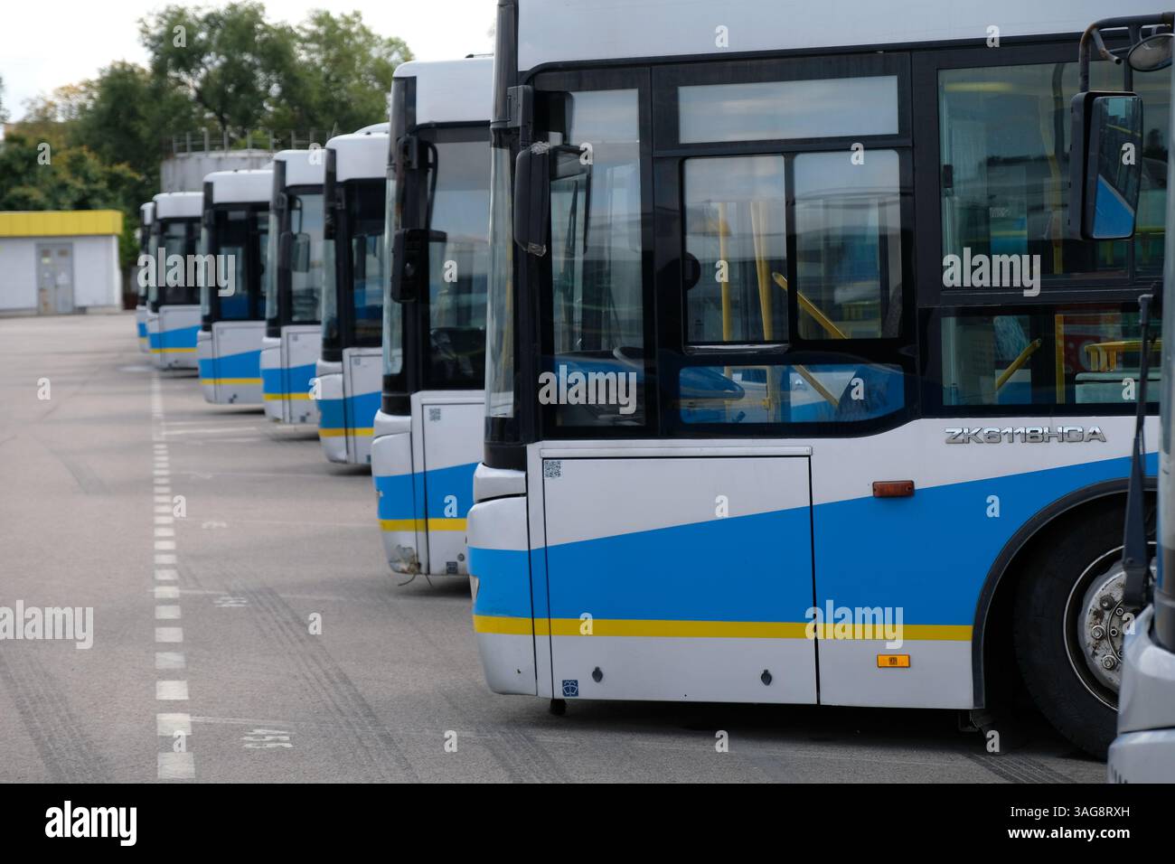 City buses stand behind each other in a large Parking lot of the fleet ...