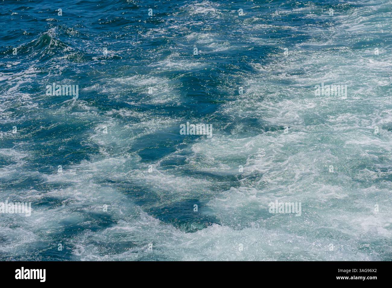 Blue ocean water with foamy surface captures water movement and water ...