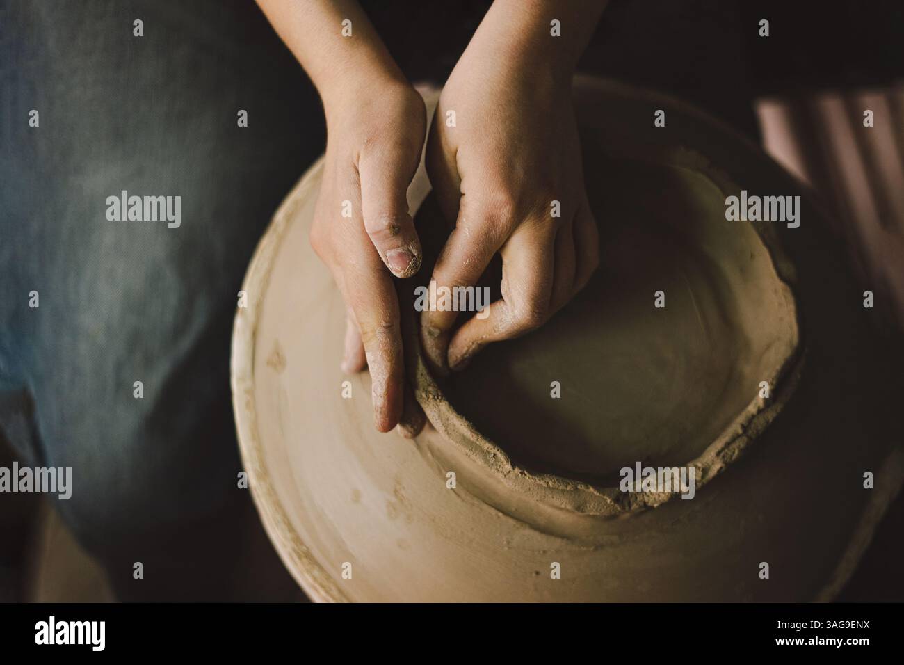 Hands skillfully shape a clay pot in a pottery studio Stock Photo - Alamy