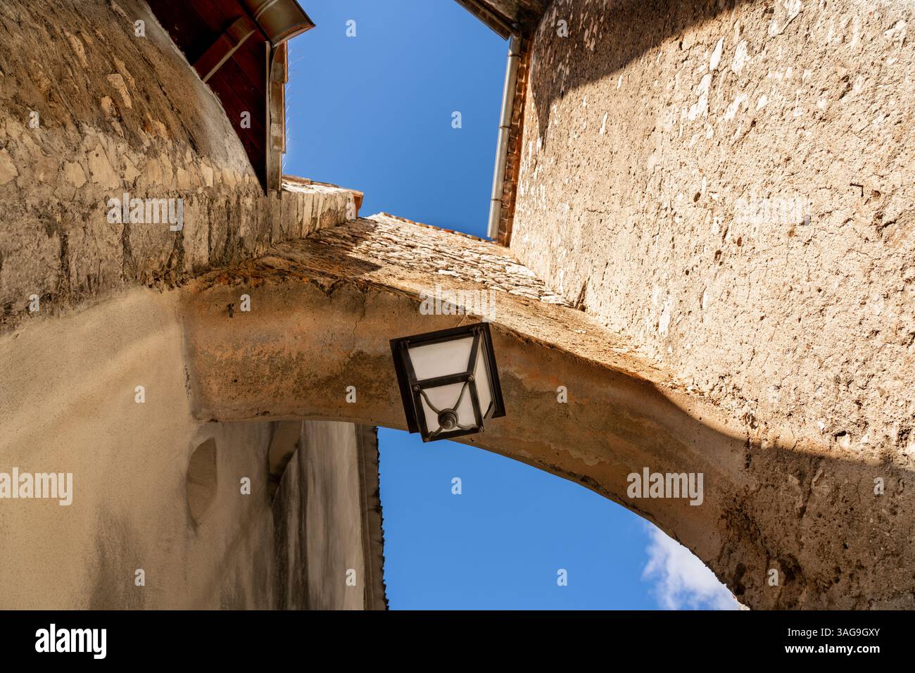 suggestive bottom-up shot of a stone arch with a traditional iron and ...