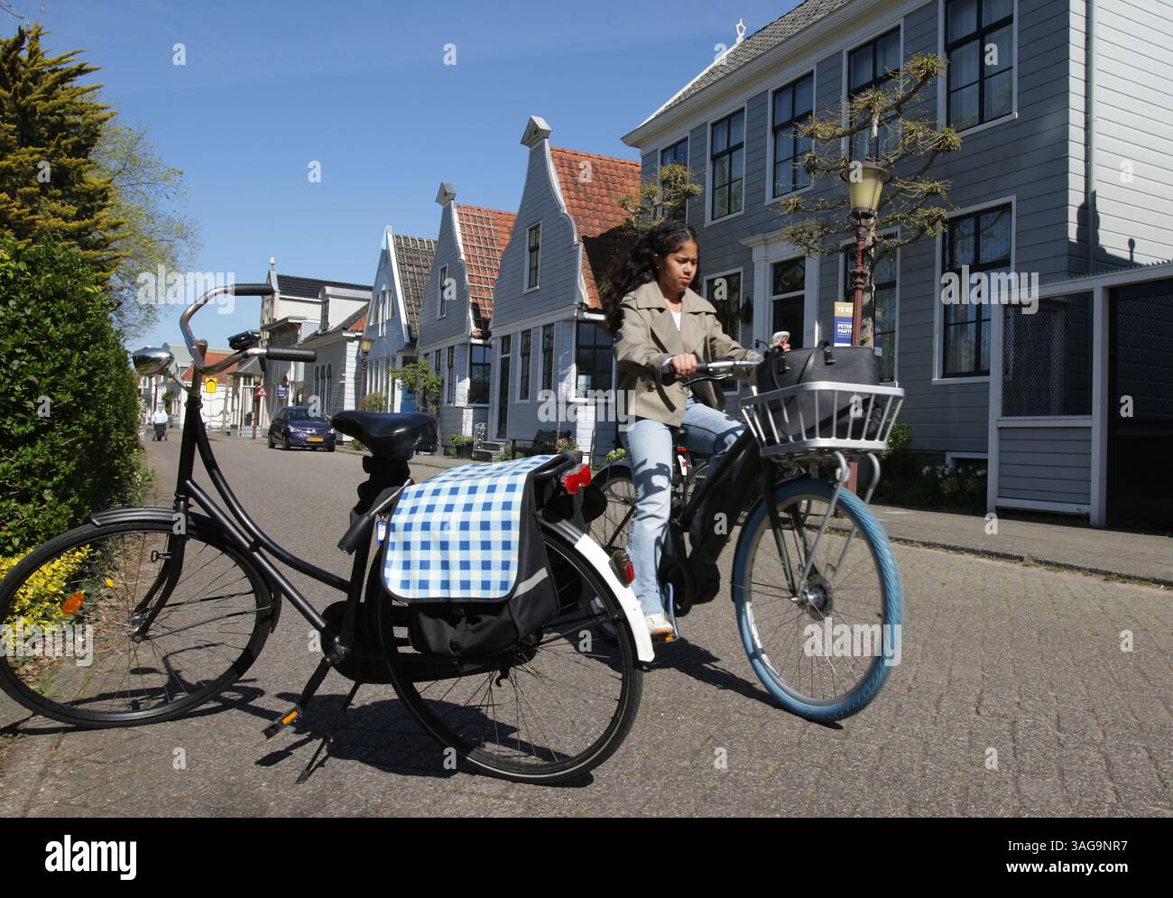 AMSTERDAM,NETHERLANDS - APRIL 8: A local rides bicycle checks her ...