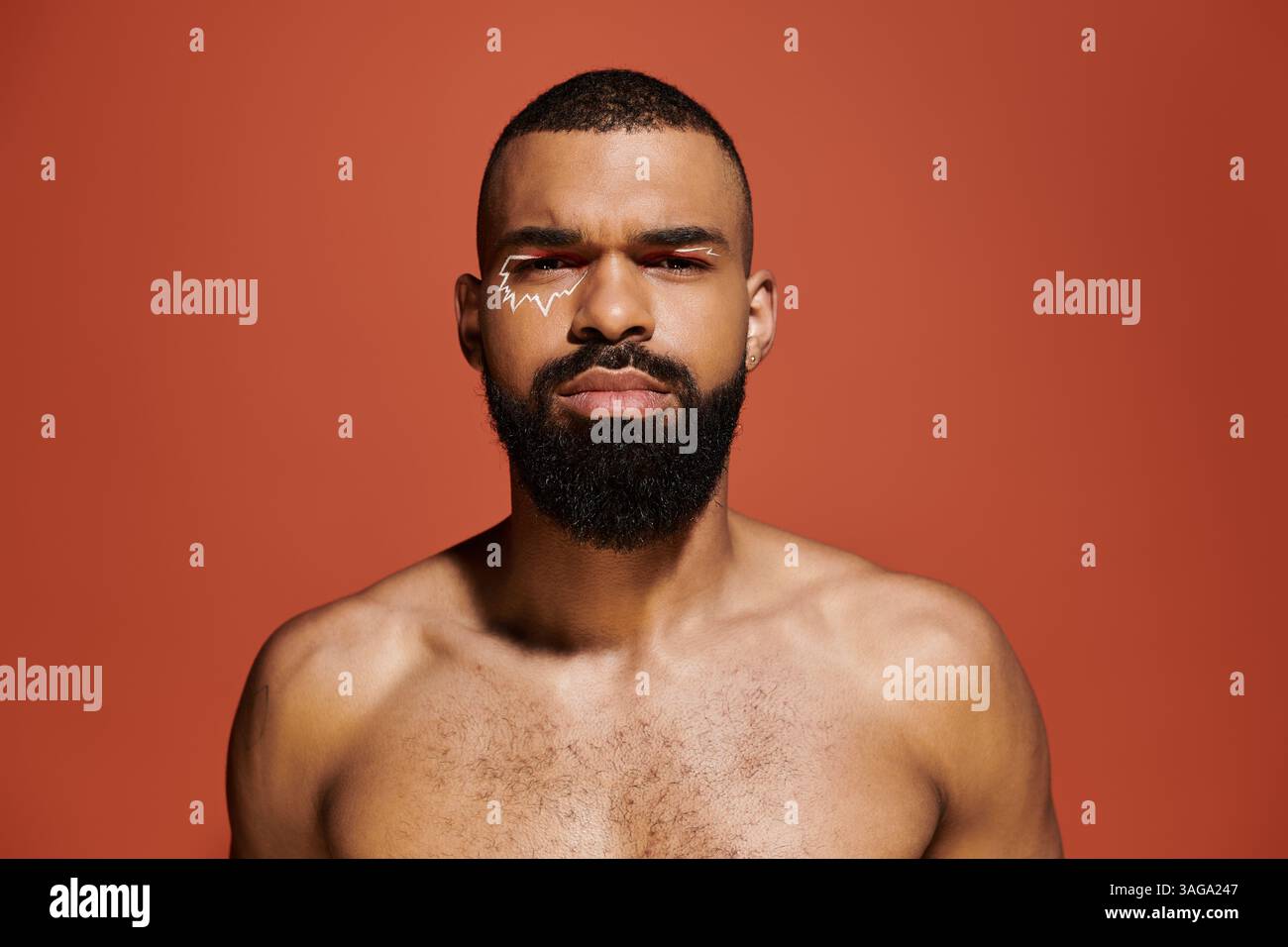 A stylish man stands confidently with bold expression and striking ...